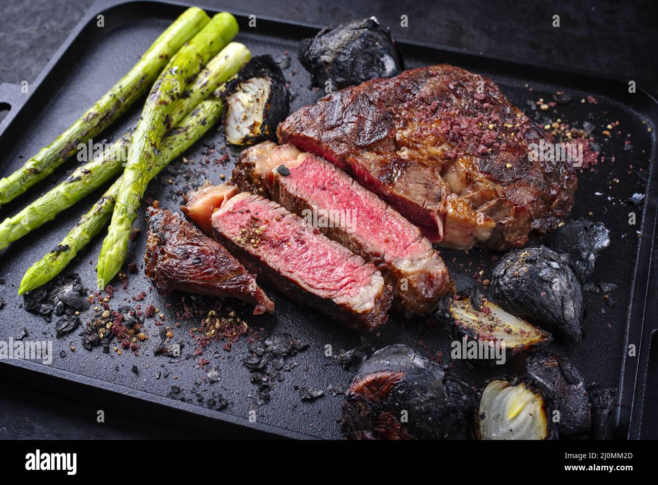 Modern style barbecue dry aged wagyu rib-eye beef steaks with green ...
