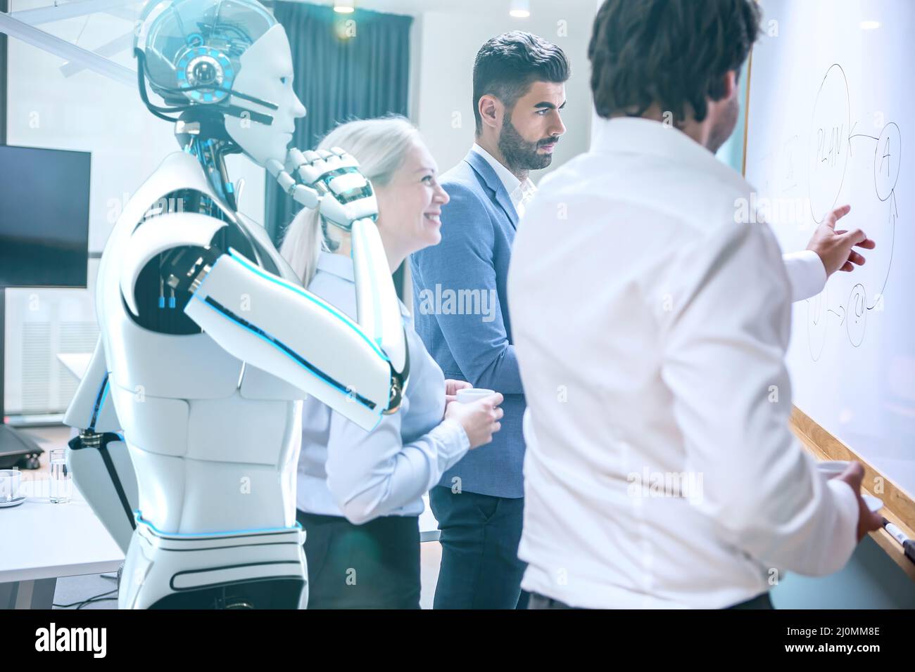 Businessmen with humanoid robot project development Stock Photo - Alamy
