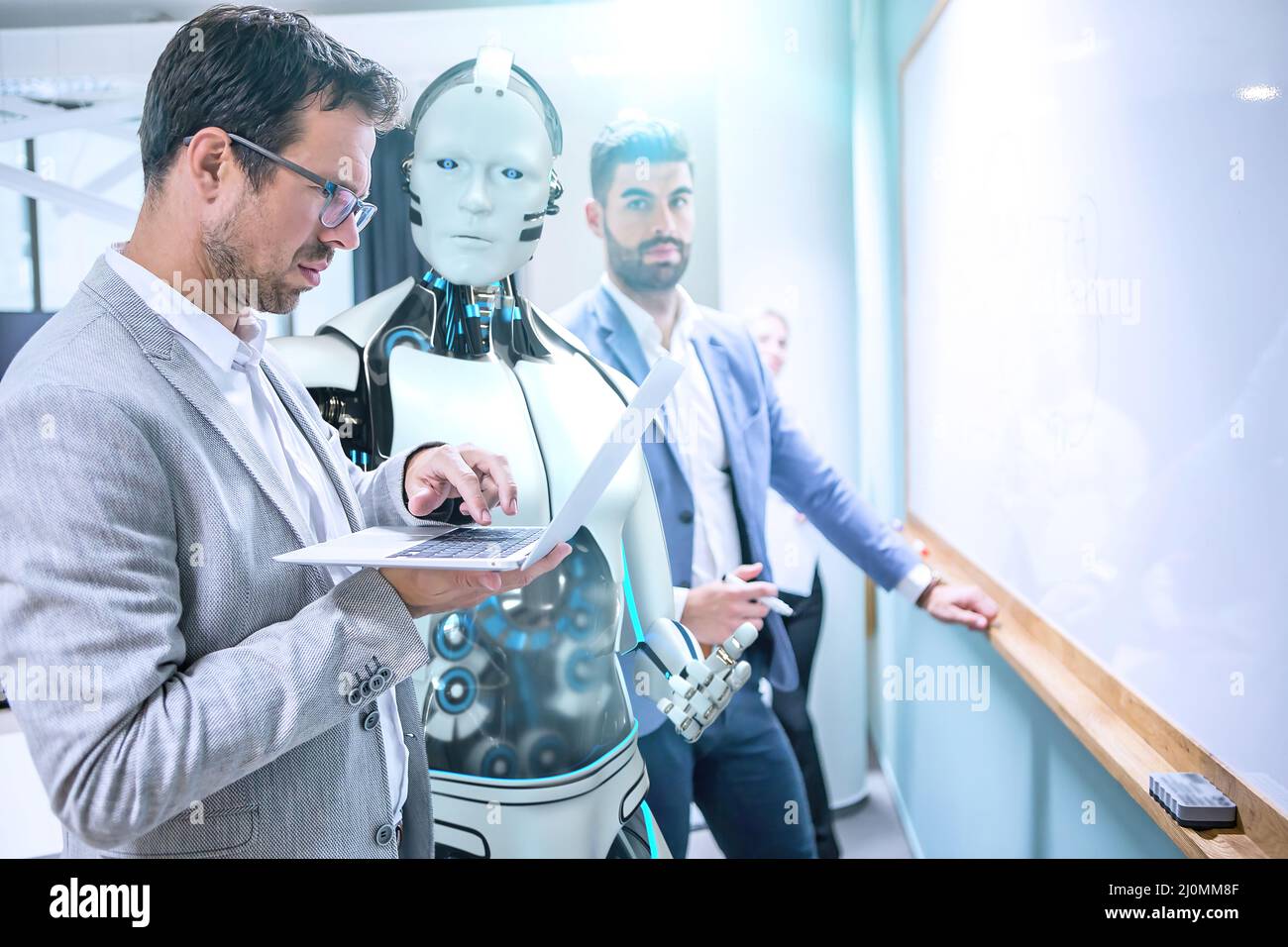 Businessmen with humanoid robot project development Stock Photo - Alamy