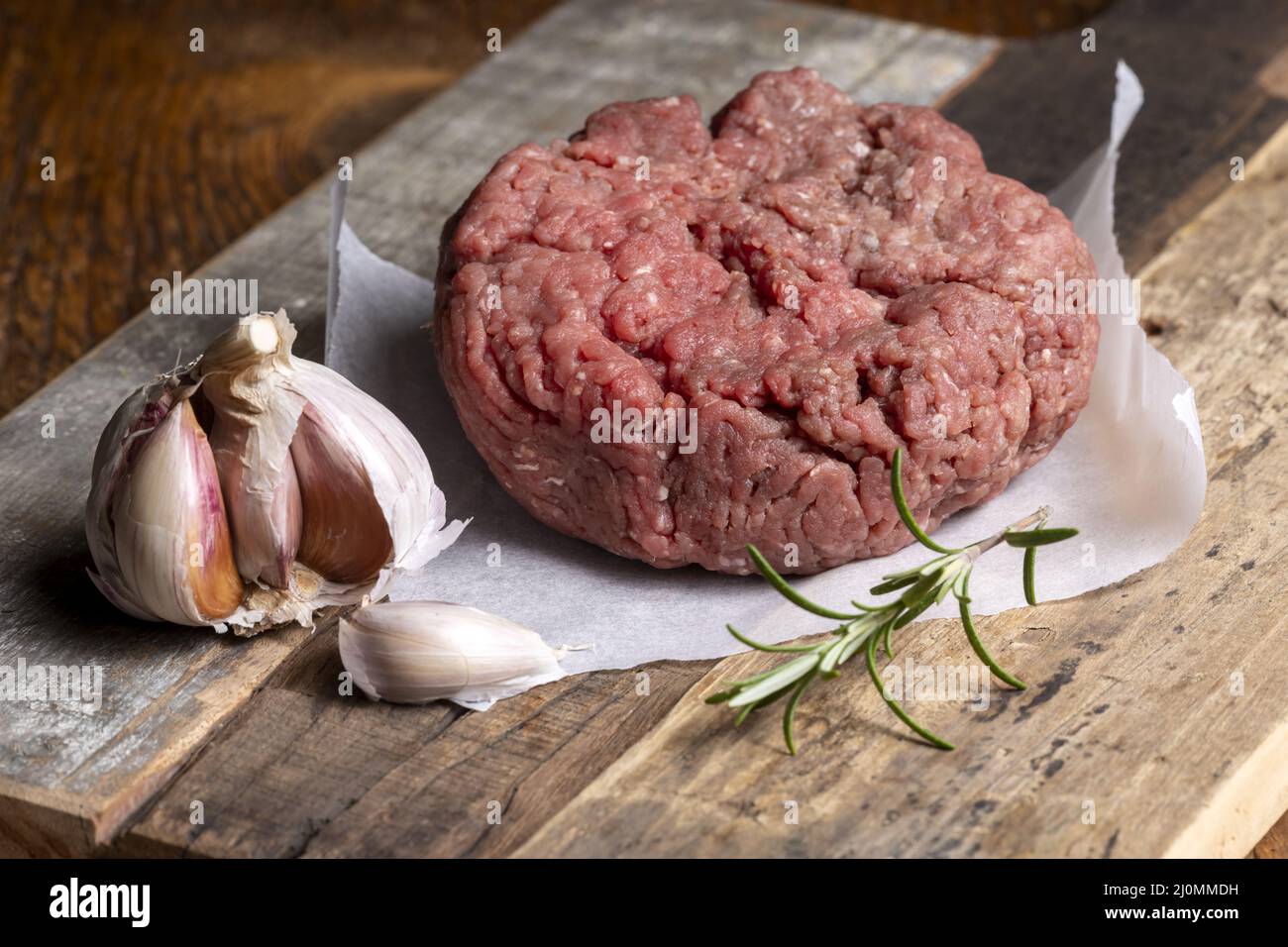 Raw minced meat on dark wood Stock Photo - Alamy