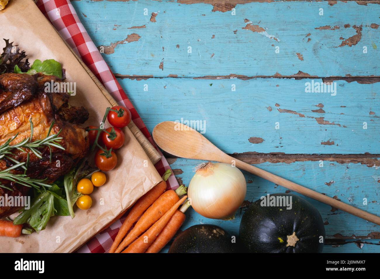 Cooked chicken and multiple food ingredients with copy space on blue ...