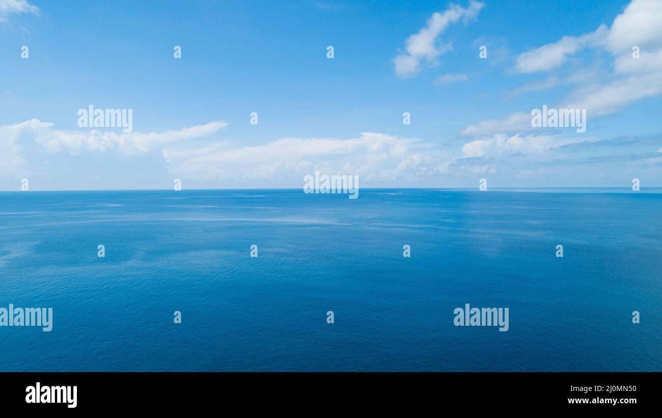 Aerial view of a blue sea surface water texture background and sun ...