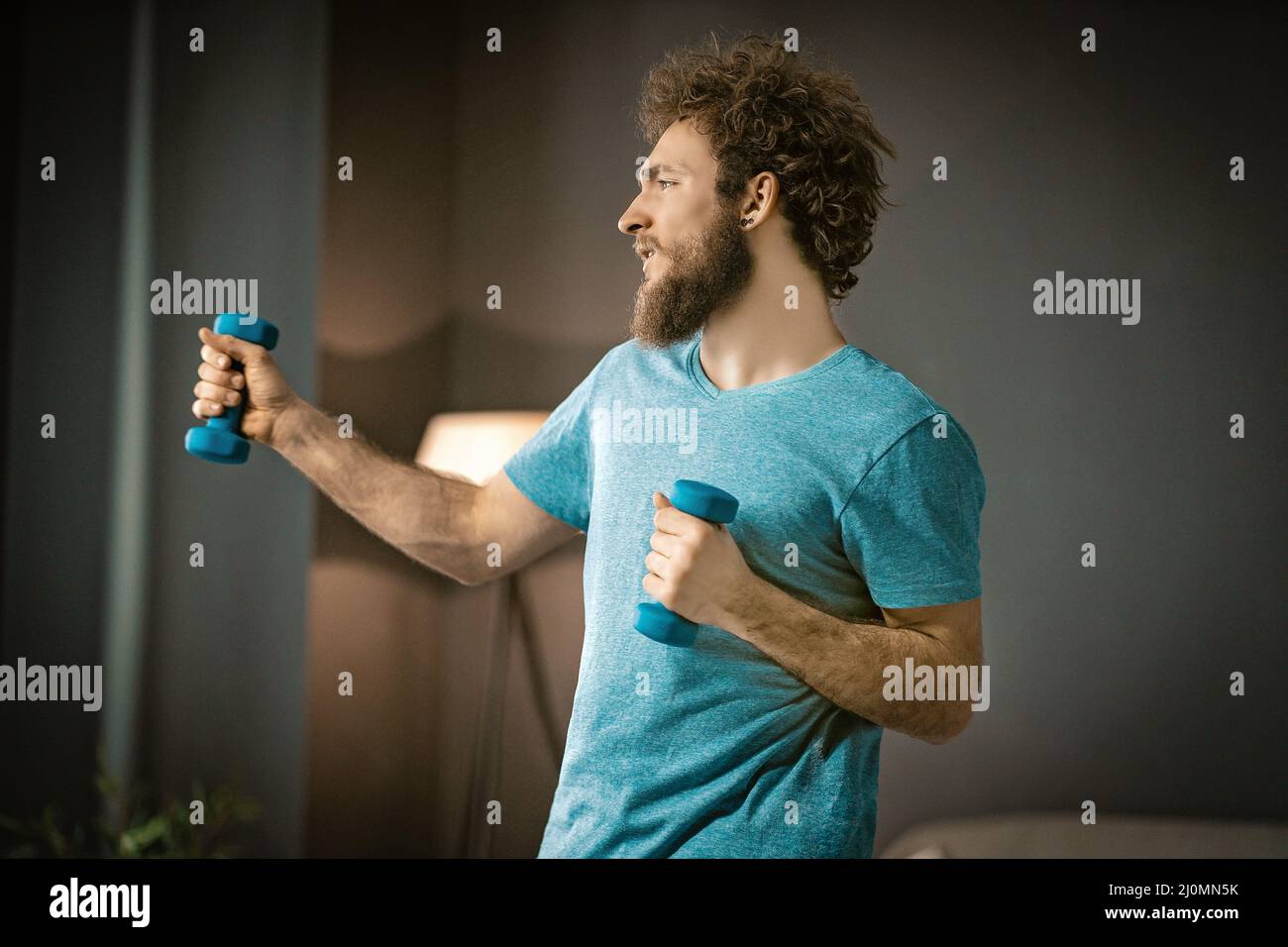 Slim White Man Doing His Morning Exercises with Dumbbells. Young Guy ...