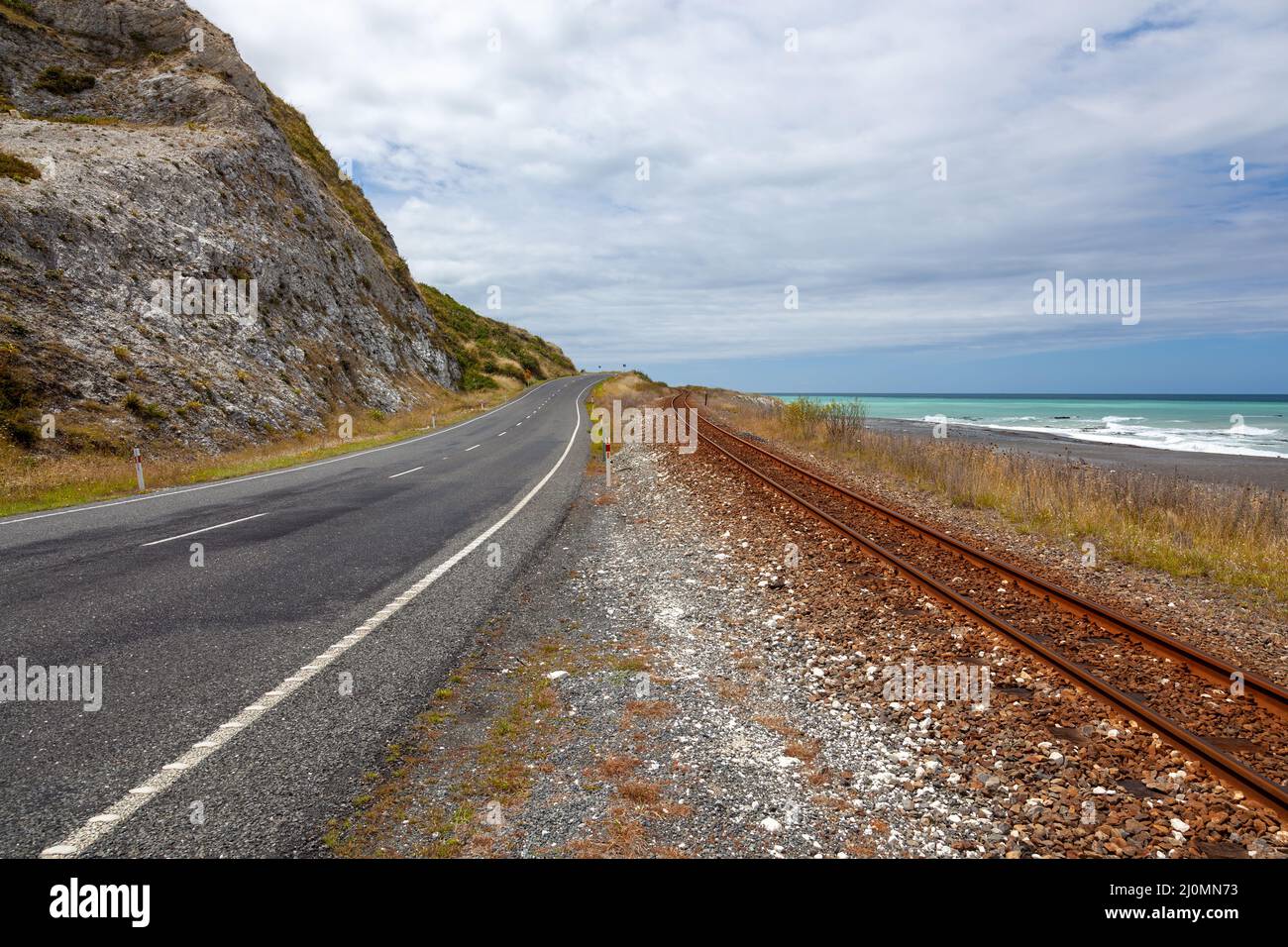 Empty road and railway track in New Zealand Stock Photo - Alamy