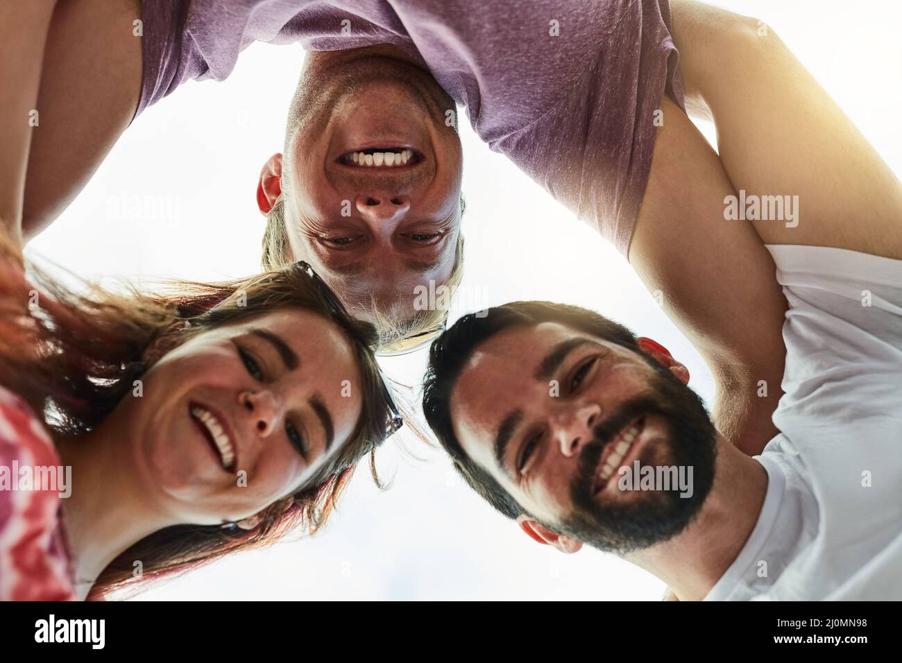 Friends fill life with the most fun. Low angle shot of a group of young ...