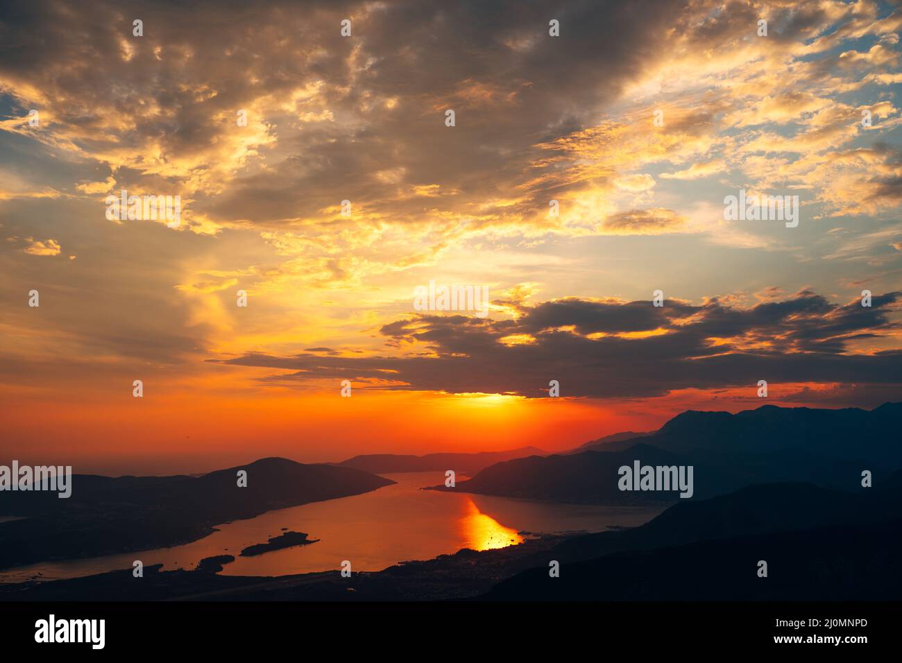 Orange clouds in the rays of the setting sun over the bay. View from ...