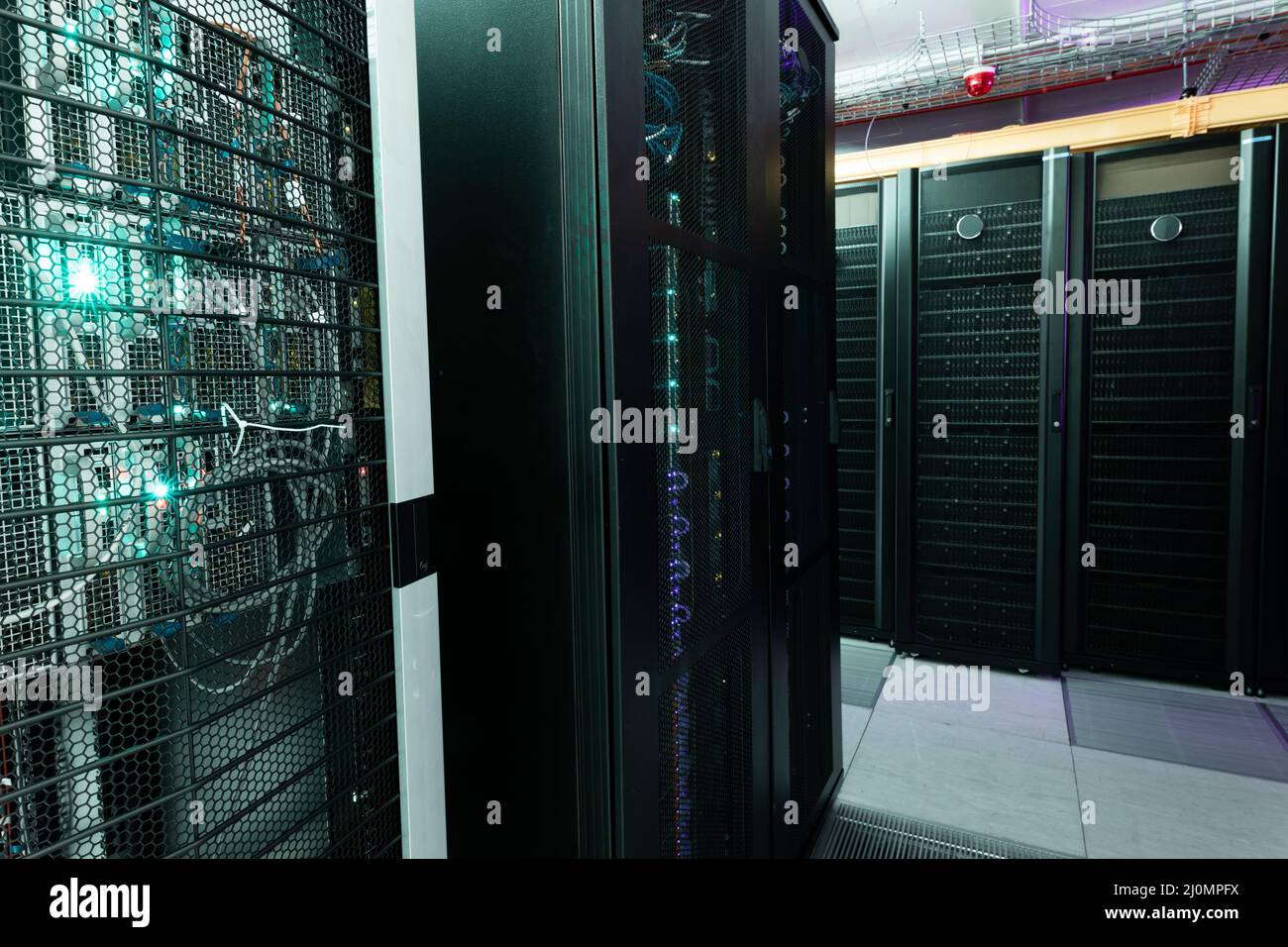 Data center with multiple rows of fully operational server racks Stock Photo - Alamy