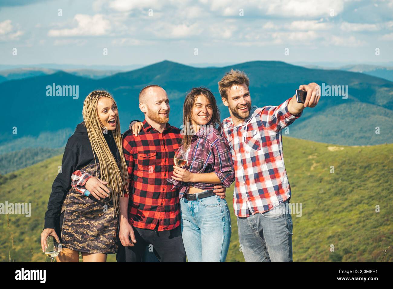Group of friends taking a selfie in the mountains. Group of hikers ...