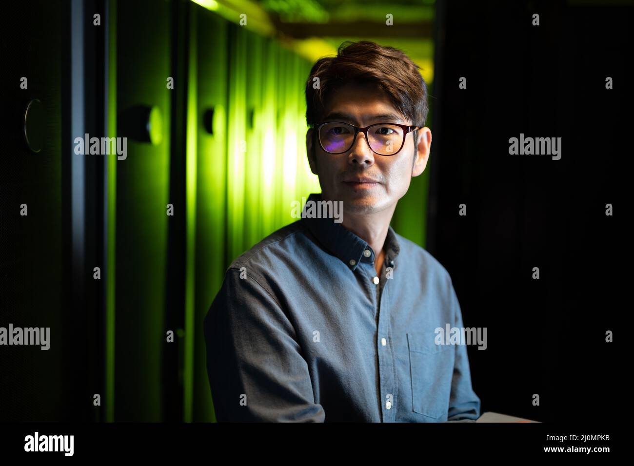 Asian male engineer using laptop in computer server room Stock Photo ...