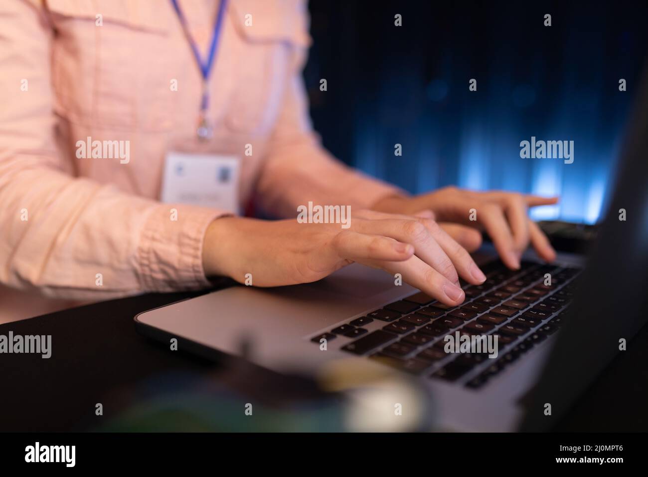 Mid section of woman using laptop in computer server room Stock Photo ...