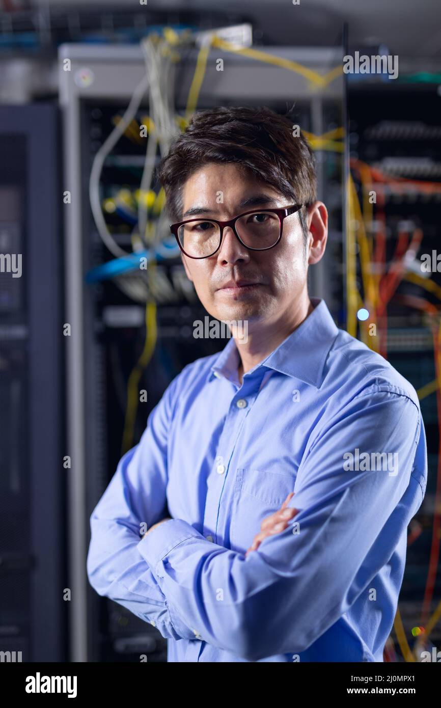 Portrait of asian male engineer with arms crossed in computer server ...