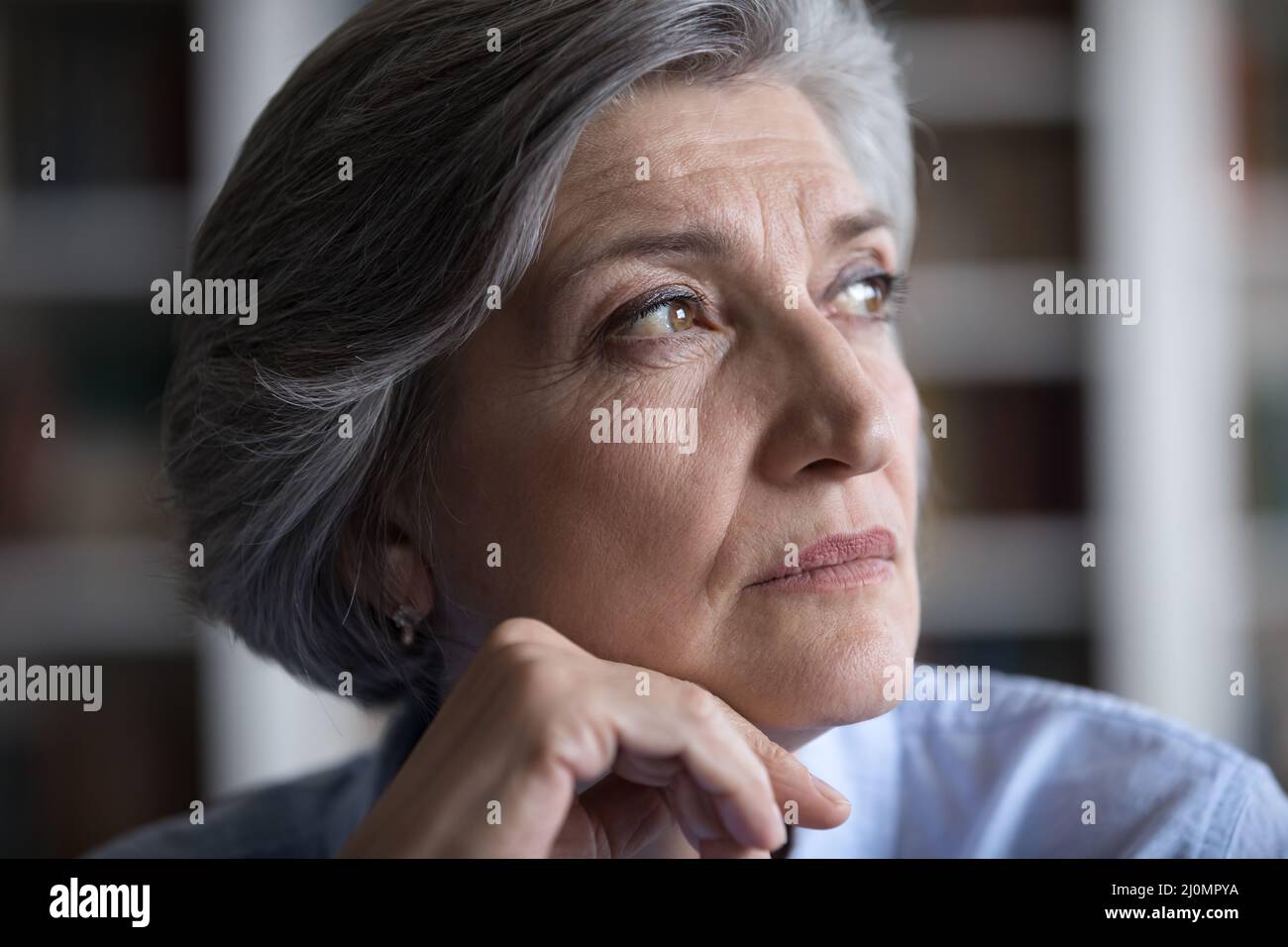 Close up face of thoughtful older businesswoman staring into distance ...