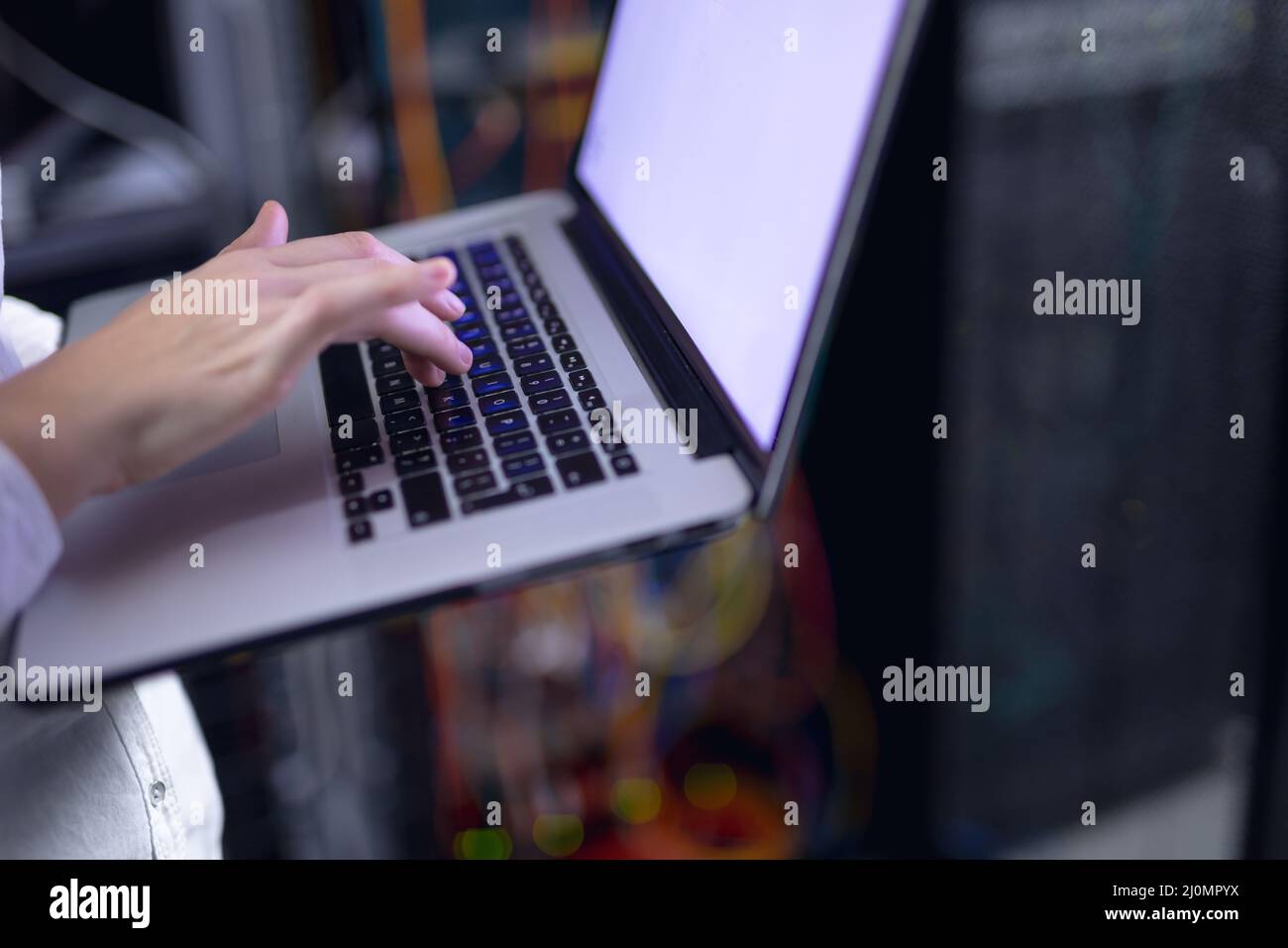 Mid section of woman laptop in computer server room Stock Photo - Alamy