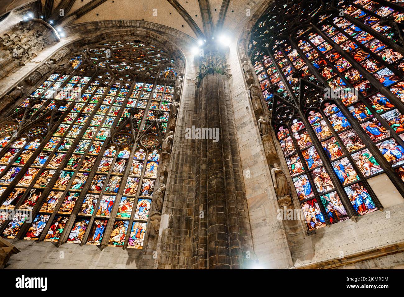 Arched vault of colored stained glass windows between the columns in ...