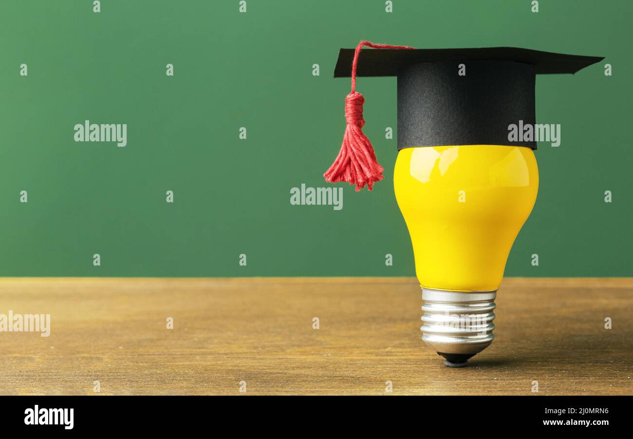Front view lightbulb with academic cap copy space Stock Photo - Alamy