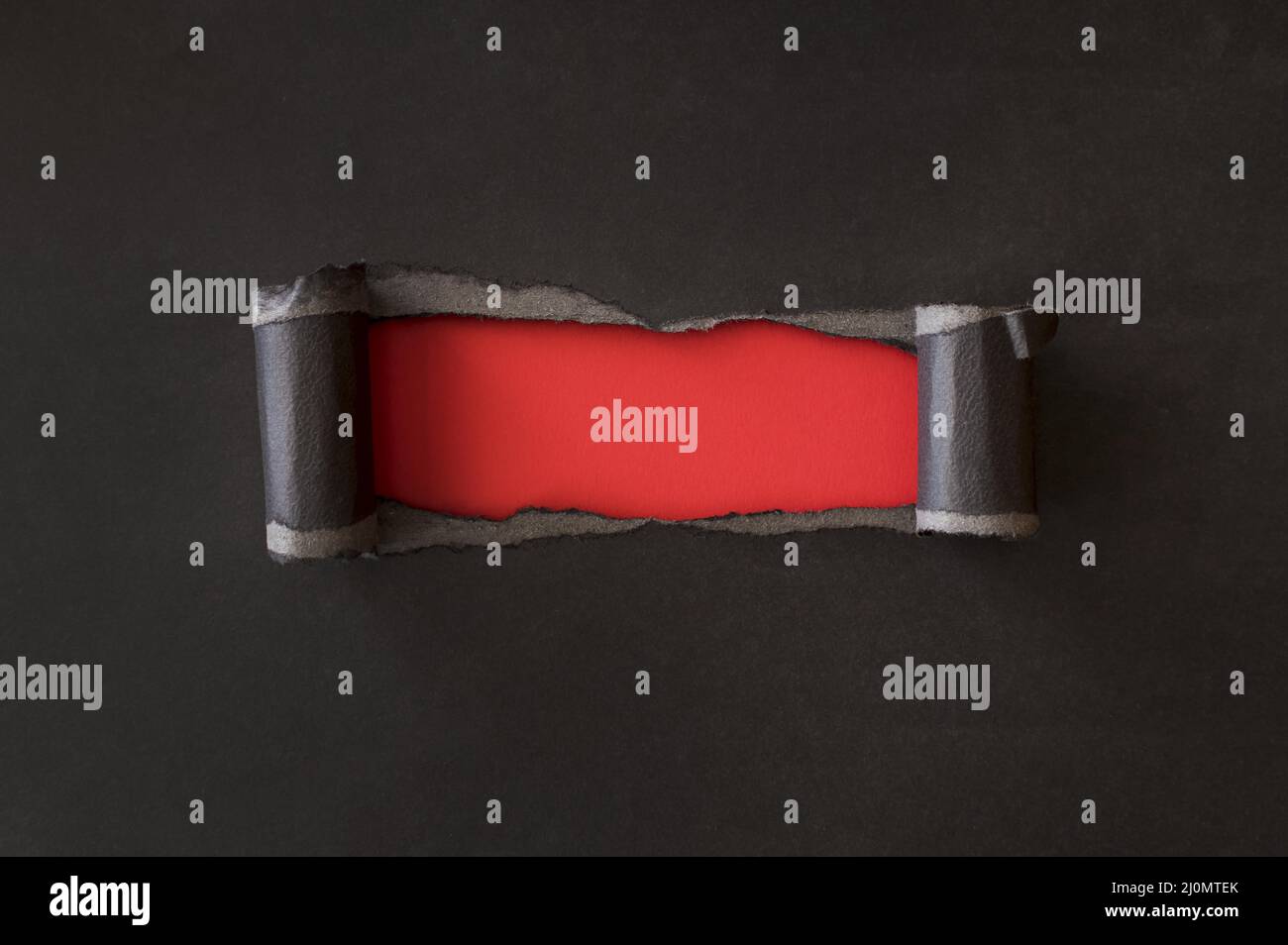 Abstract torn black paper revealing red paper Stock Photo - Alamy