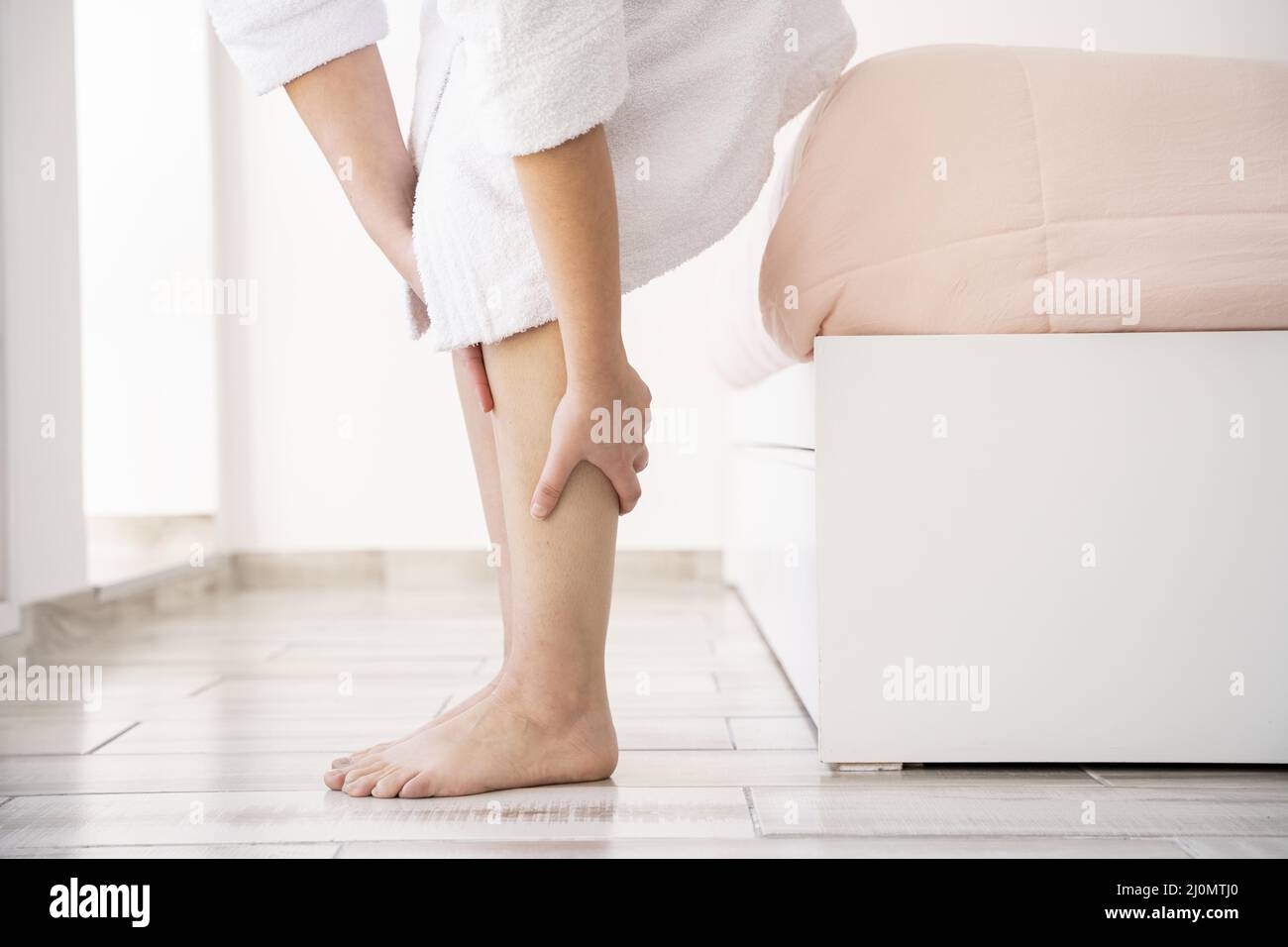 Close up hands massaging legs Stock Photo - Alamy