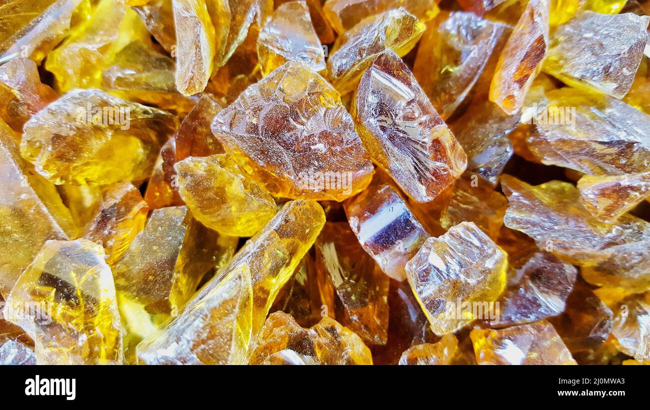 Amber color fire glass shards closeup with selective focus in the ...