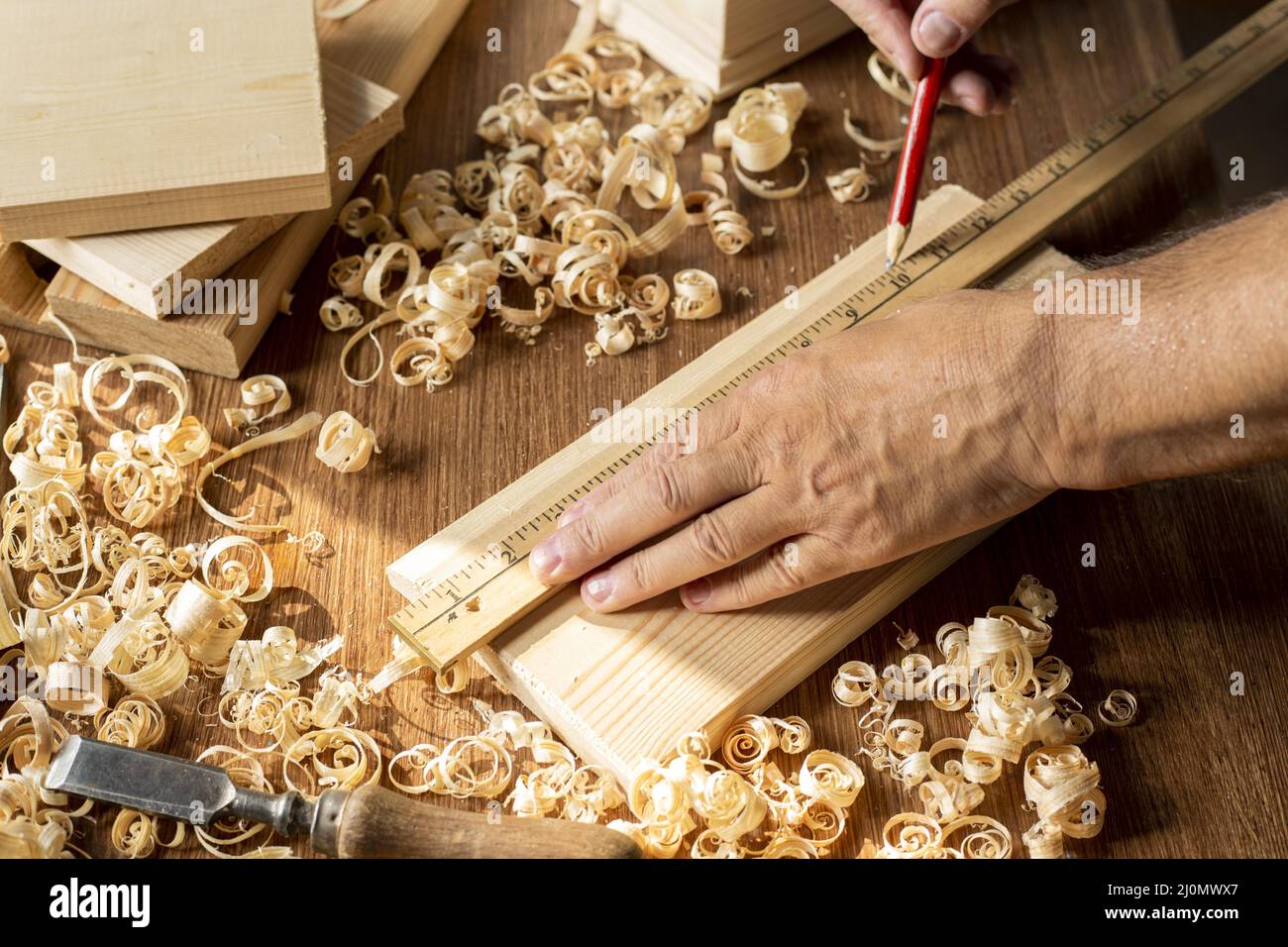 Carpenter working piece wood with pencil Stock Photo - Alamy