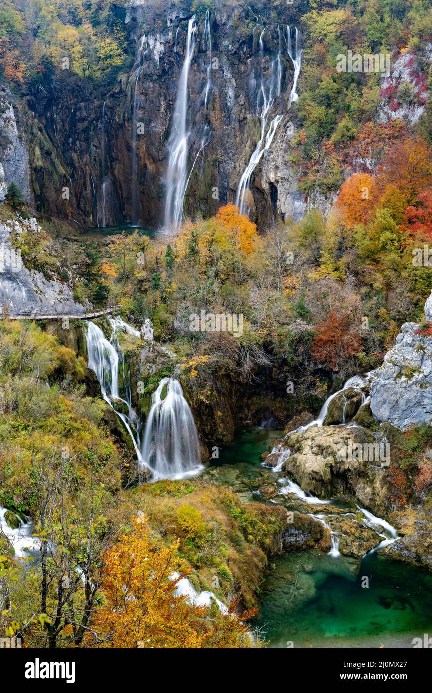 A vertical view of the great waterfalls in Plitivice with vibrant and ...