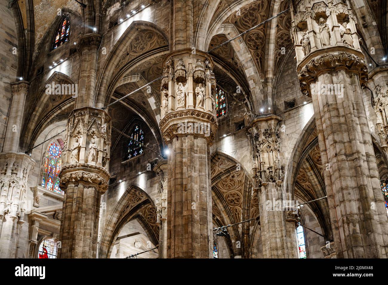High carved columns with statues in the Duomo. Italy, Milan Stock Photo ...