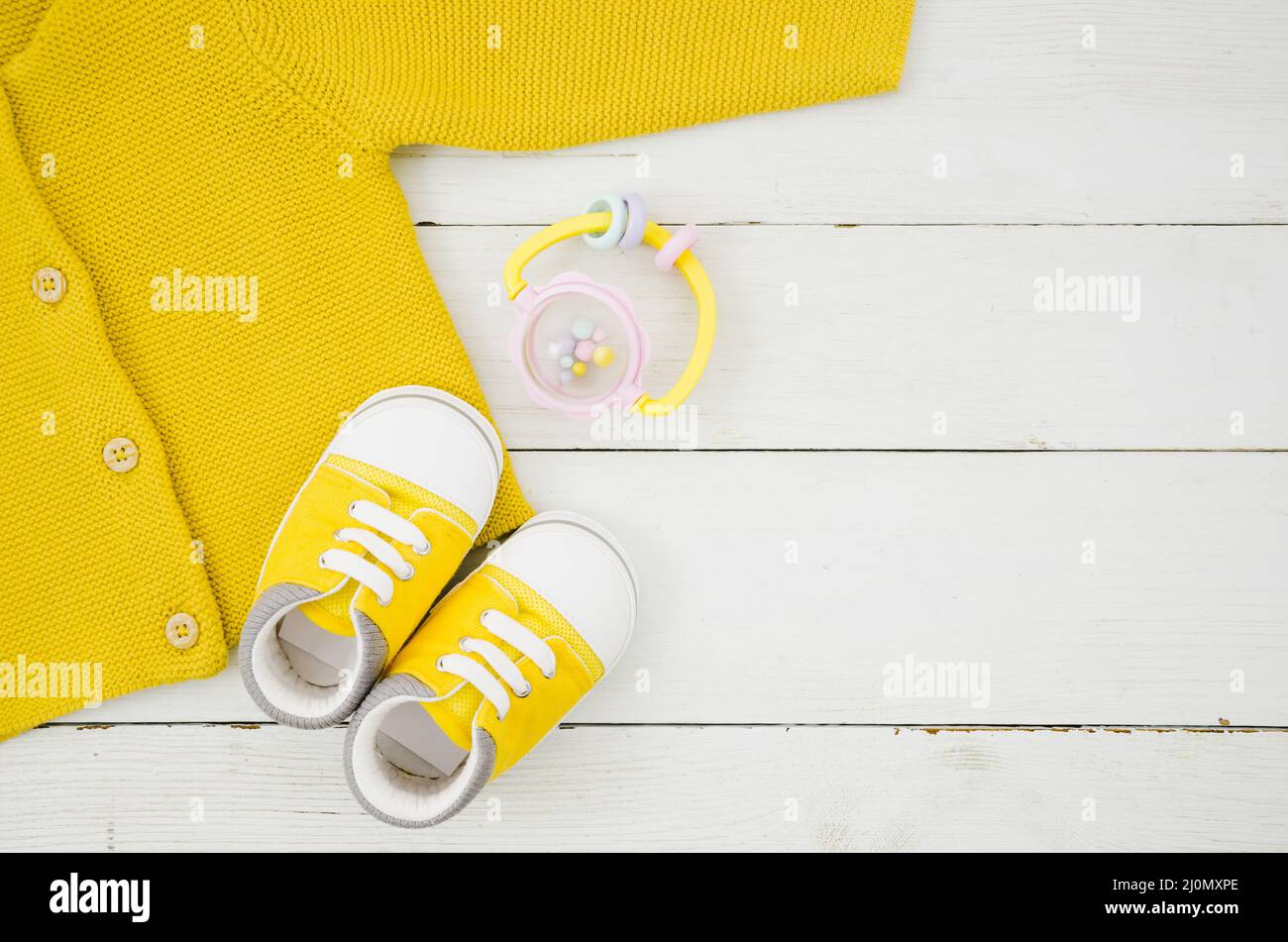 Flat lay baby clothes with wooden background Stock Photo - Alamy