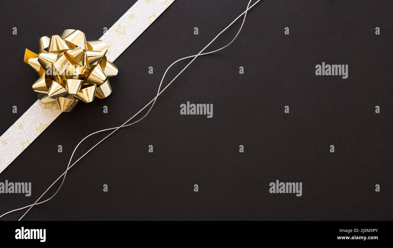 Decorative ribbon bow silver string black background Stock Photo - Alamy
