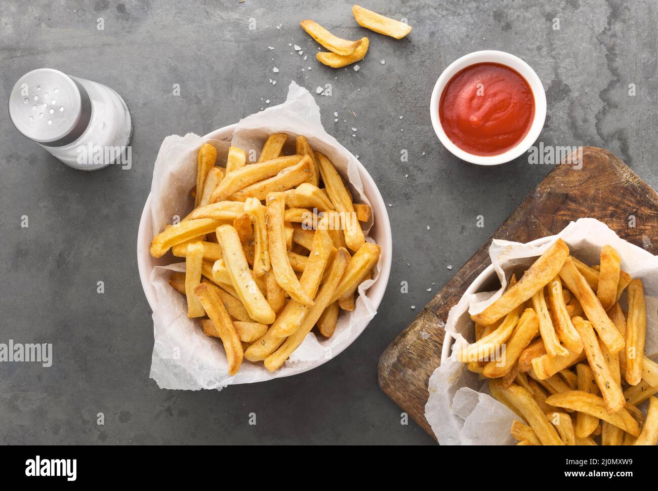 Flat lay french fries with ketchup salt shaker Stock Photo - Alamy