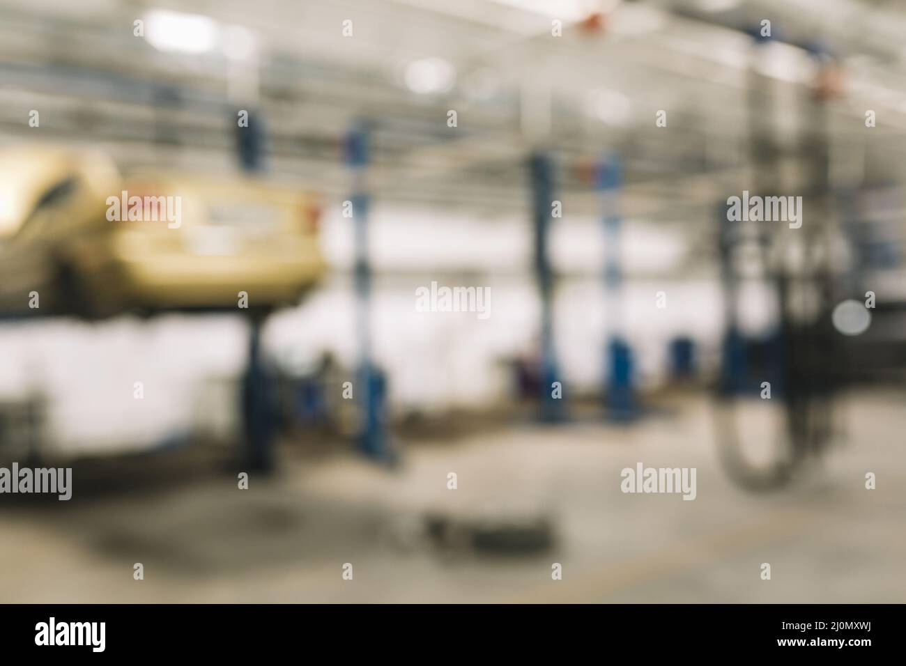 Blurred car repair shop Stock Photo - Alamy