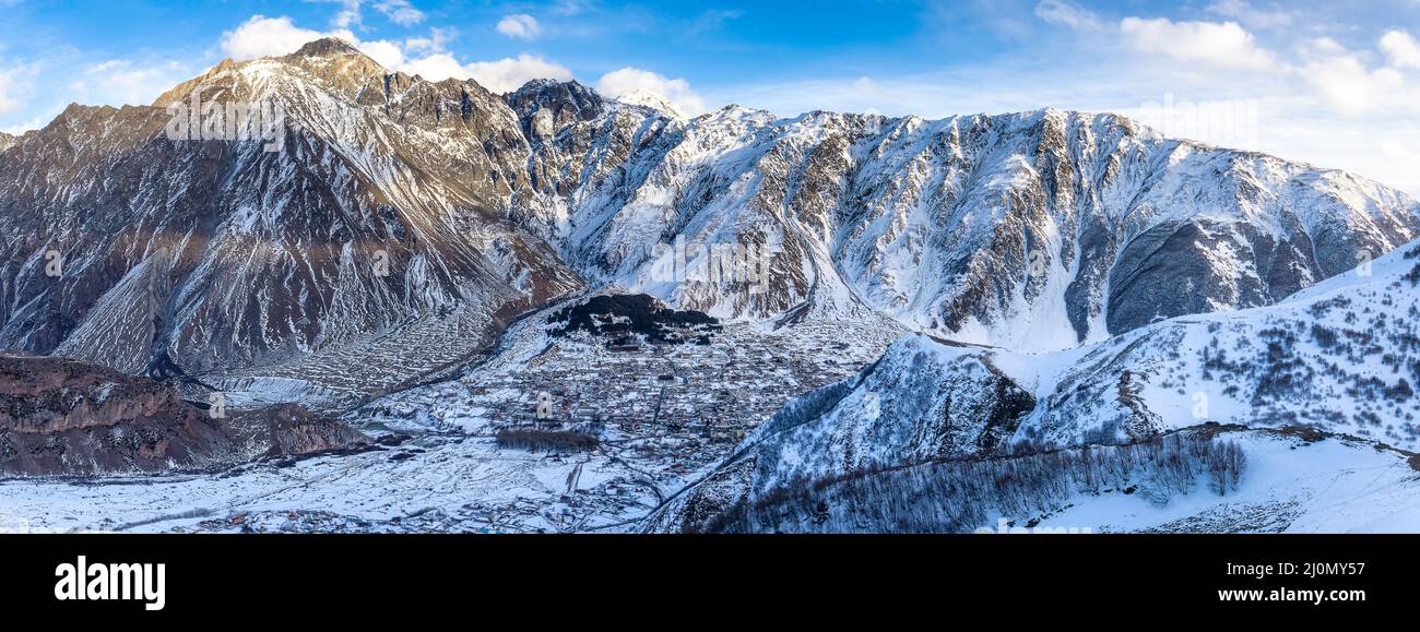 Winter panorama of Kazbegi (Stepantsminda) town and caucasus rocky ...