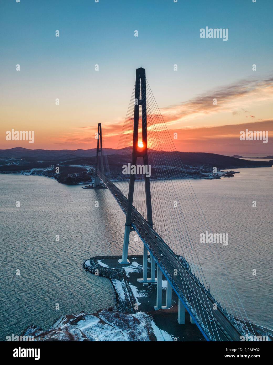 Winter aerial view of sunset over famous cable-stayed bridge from ...