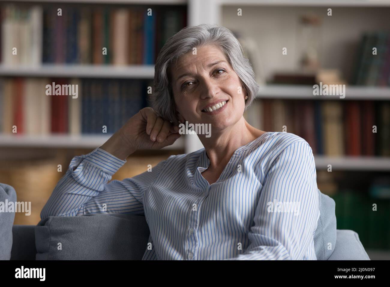 Calm attractive middle-aged single woman relaxing on couch Stock Photo ...