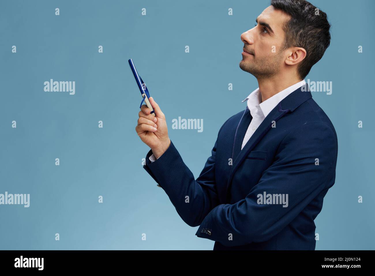 successful man looking up with a blue notepad emotions business and ...