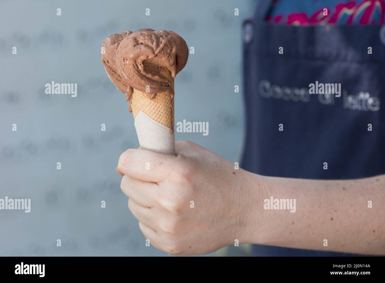 Chocolate ice cream cone in hand Stock Photo - Alamy