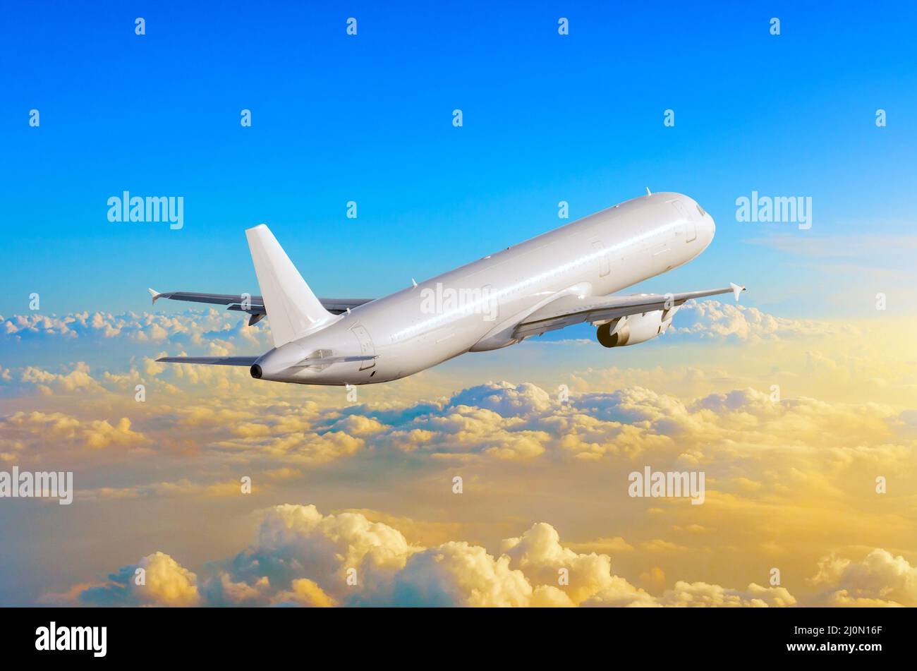 Flying airplane above the clouds horizon sky with bright sunset colors ...