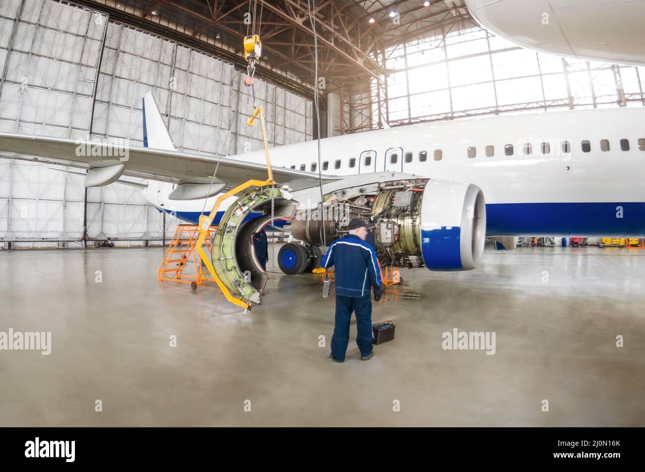 Replacing the engine on the airplane, working worker, mechanic ...