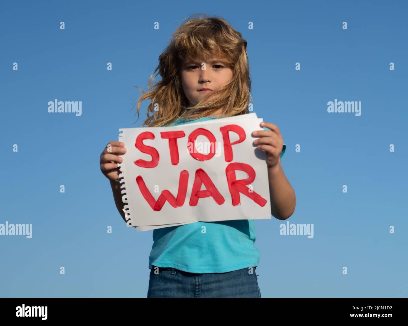 Child protest against war. Portrait kid boy calls to Stop war, raises ...