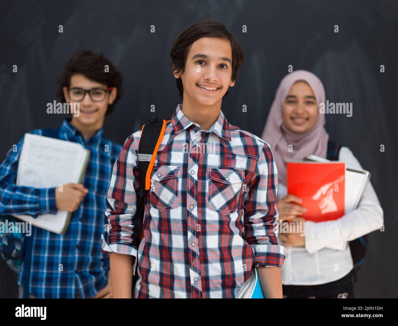 Arabic teenagers team, students group working together on laptop and ...