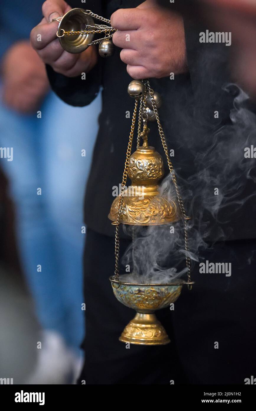 Male holding a smoky golden censer during a wedding ceremony Stock ...