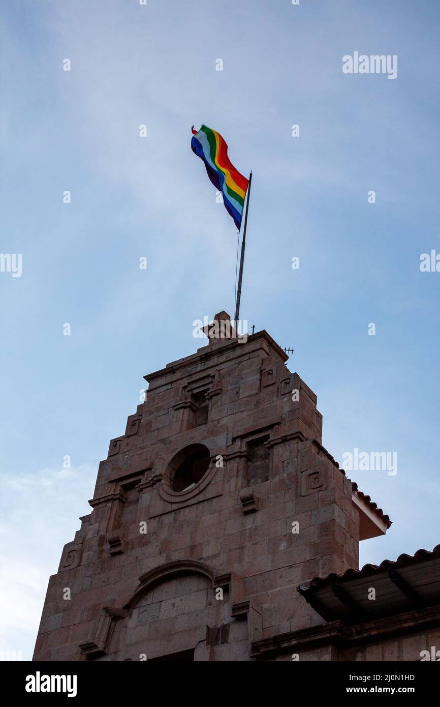 Beautiful view of a Rainbow flag on top of a historical tower in ...