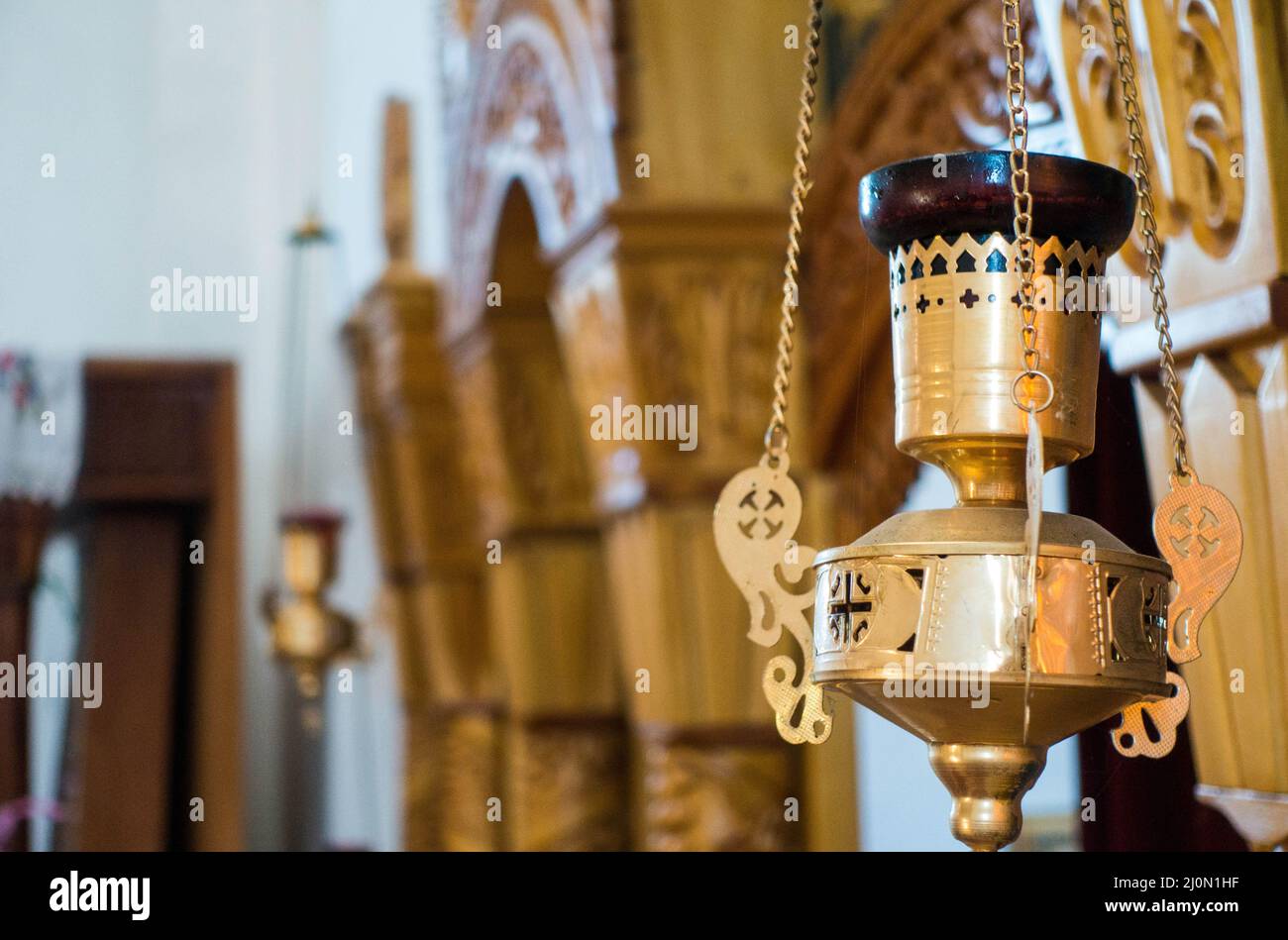 Golden lamp hanging inside the Catholic Church Stock Photo - Alamy