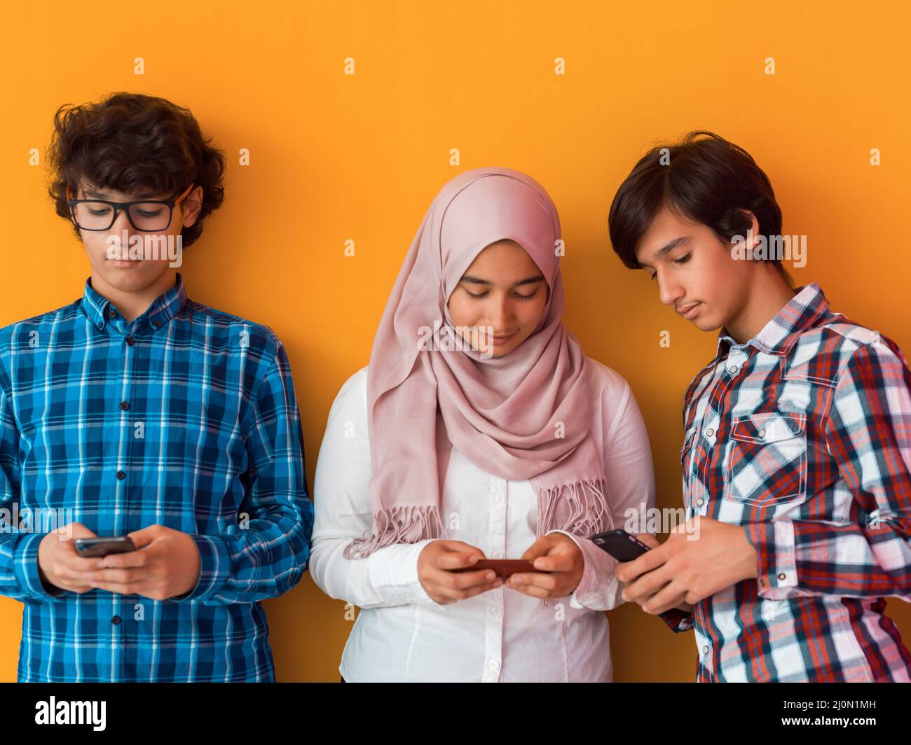 Arab teenagers group using smart phones for social media networking and ...