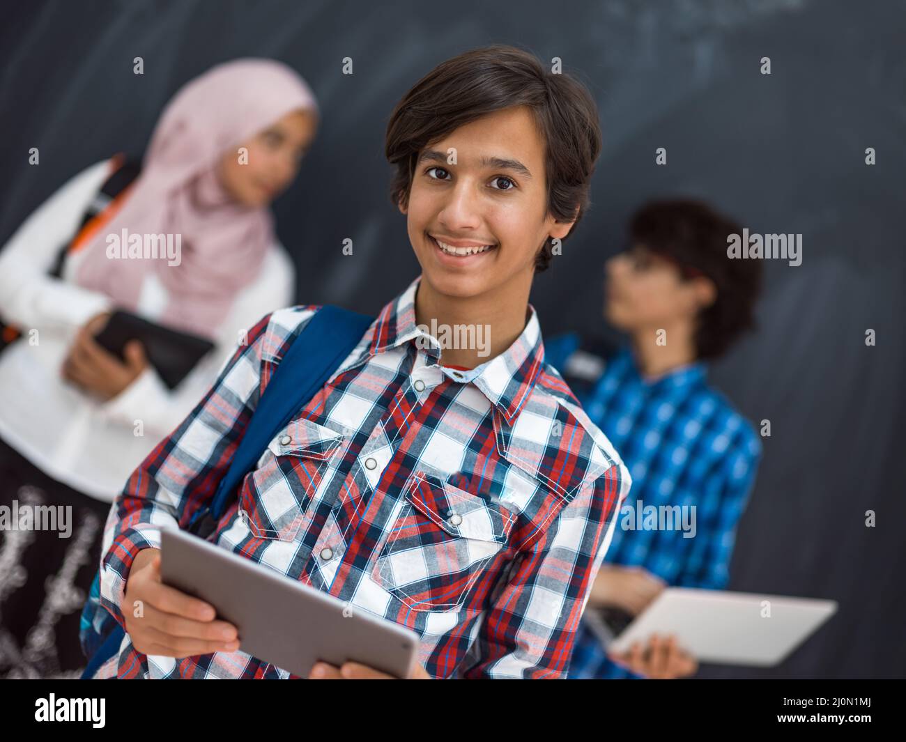 Modern arab teens use smartphone, tablet and latpop to study during ...