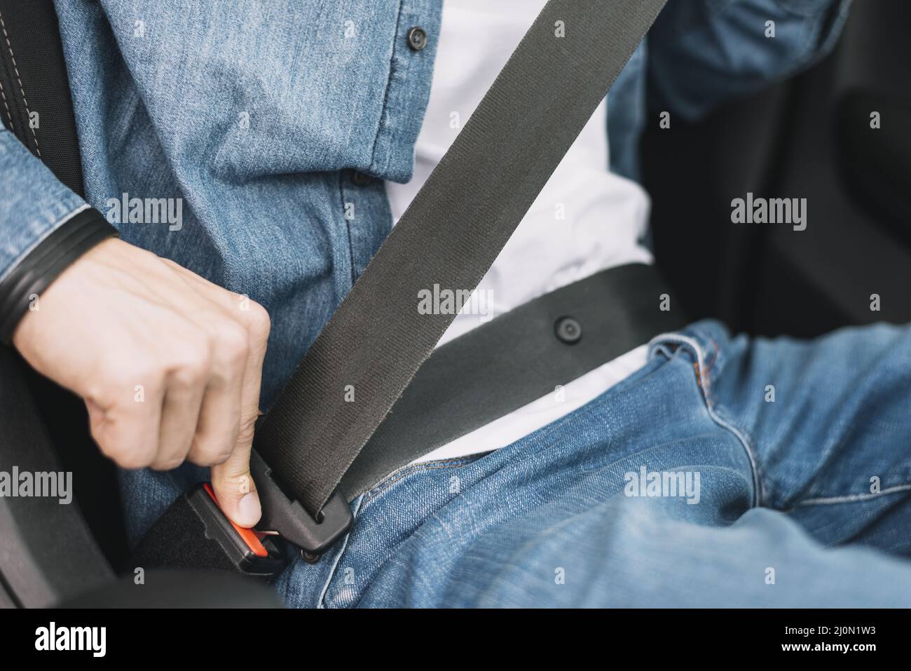 Close up man putting safety belt Stock Photo - Alamy