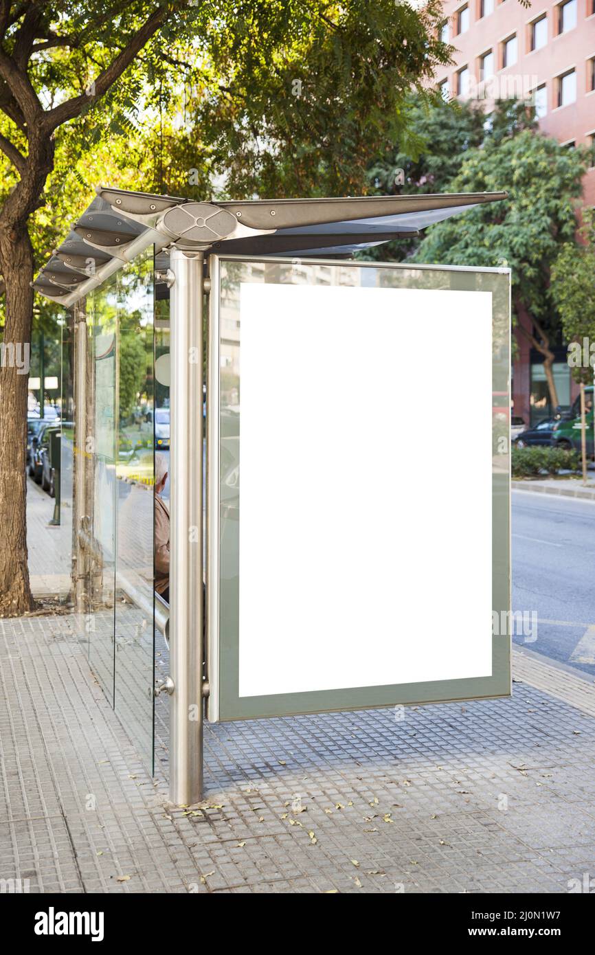 Billboard at bus stop with trees Stock Photo - Alamy