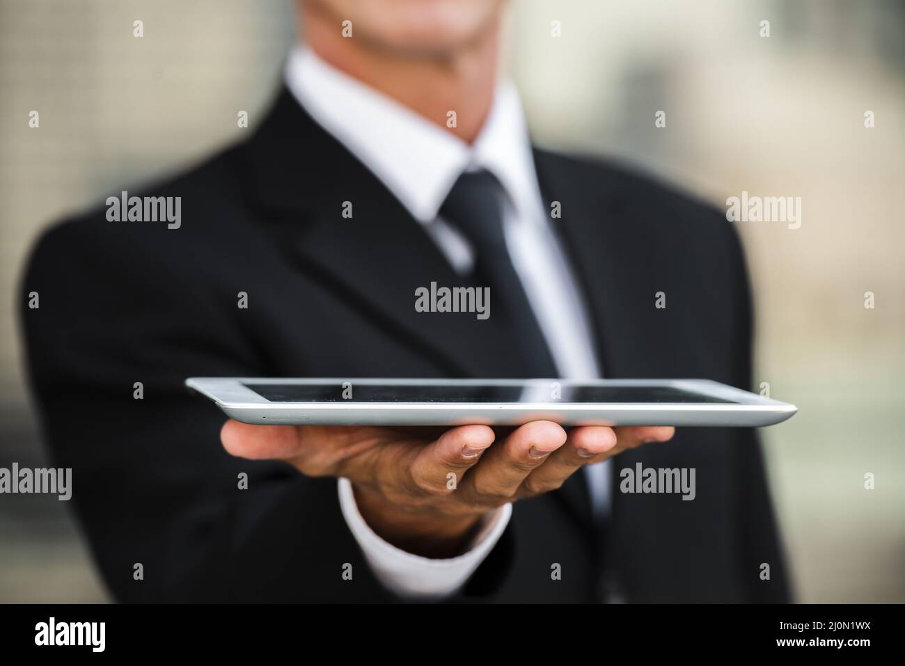 Close up businessman holding tablet hand Stock Photo - Alamy