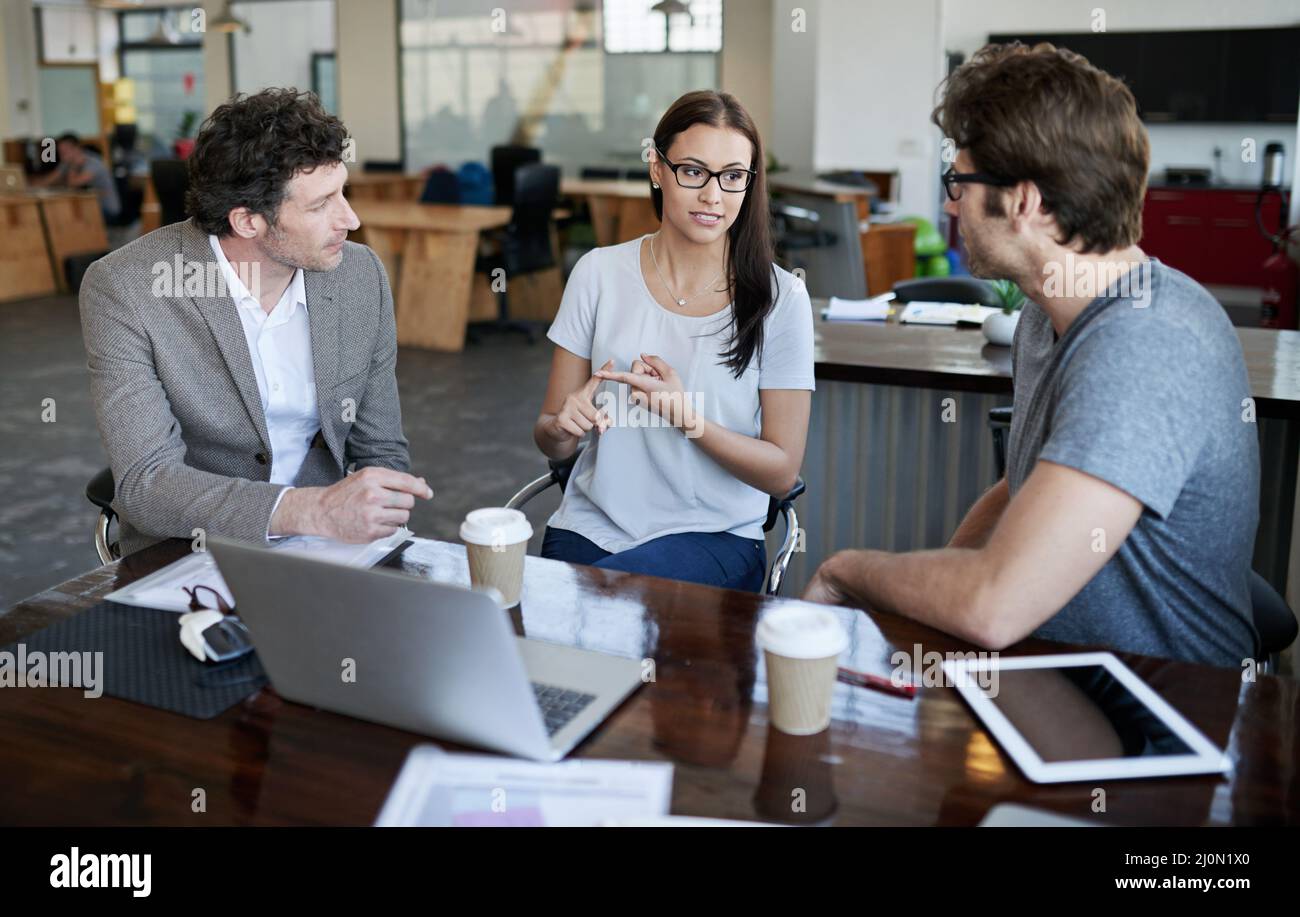 THe ideas are flowing. Shot of three coworkers talking together in an ...
