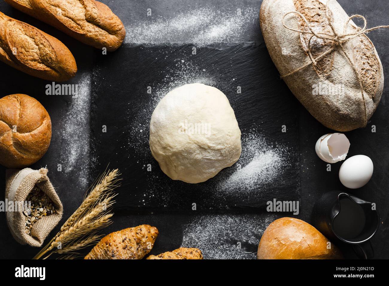 Flat lay dough bread black background Stock Photo - Alamy