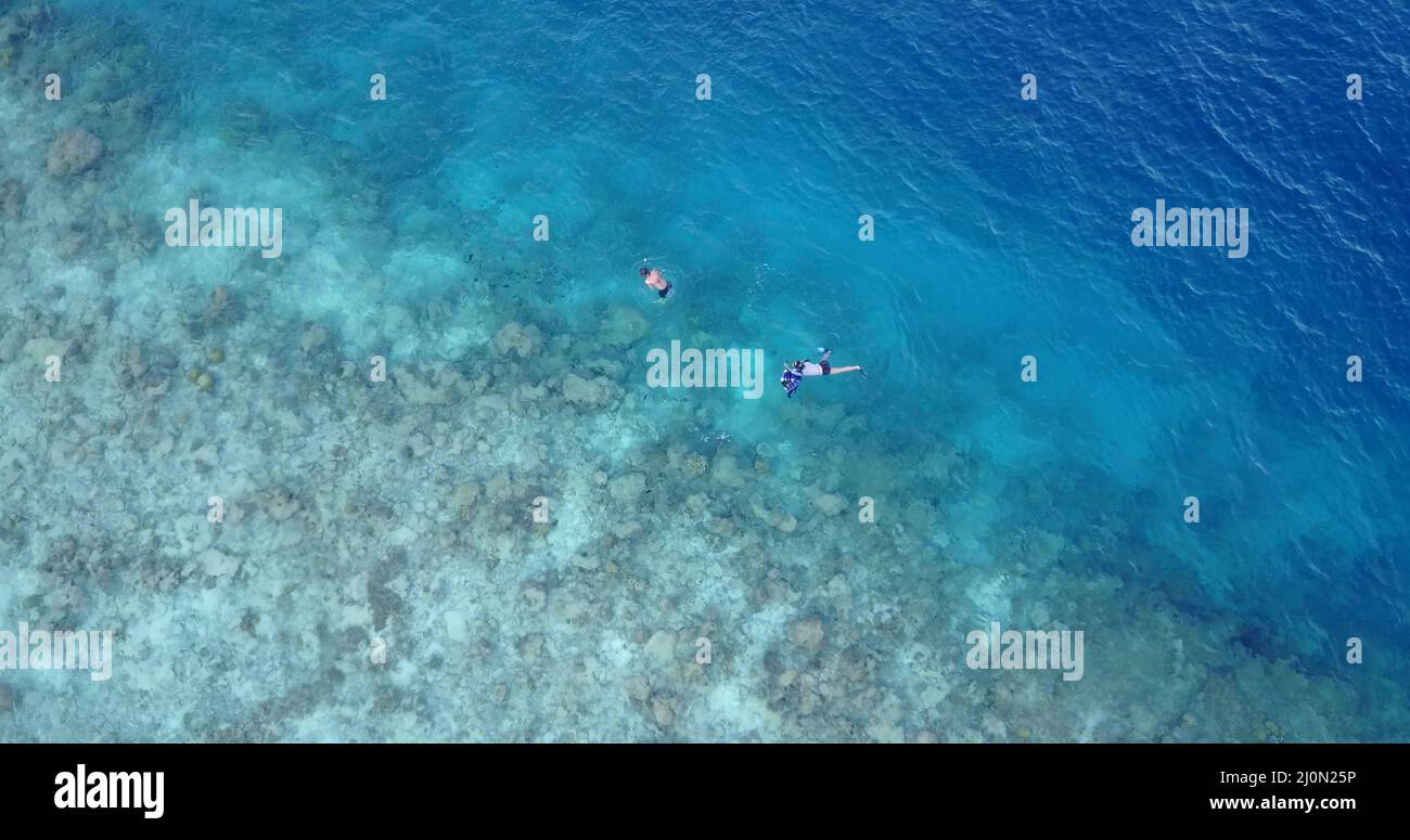 Aerial view of a swimming Caucasian couple in Rasdhoo Island, The ...