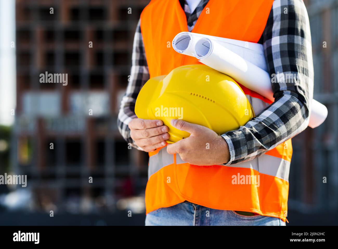Close up construction engineer holding helmet Stock Photo - Alamy